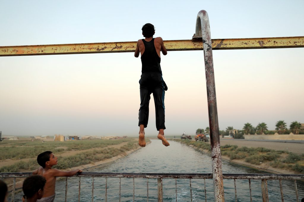 PHOTOS: How Syrian kids play and cool off outside war zones | PBS News
