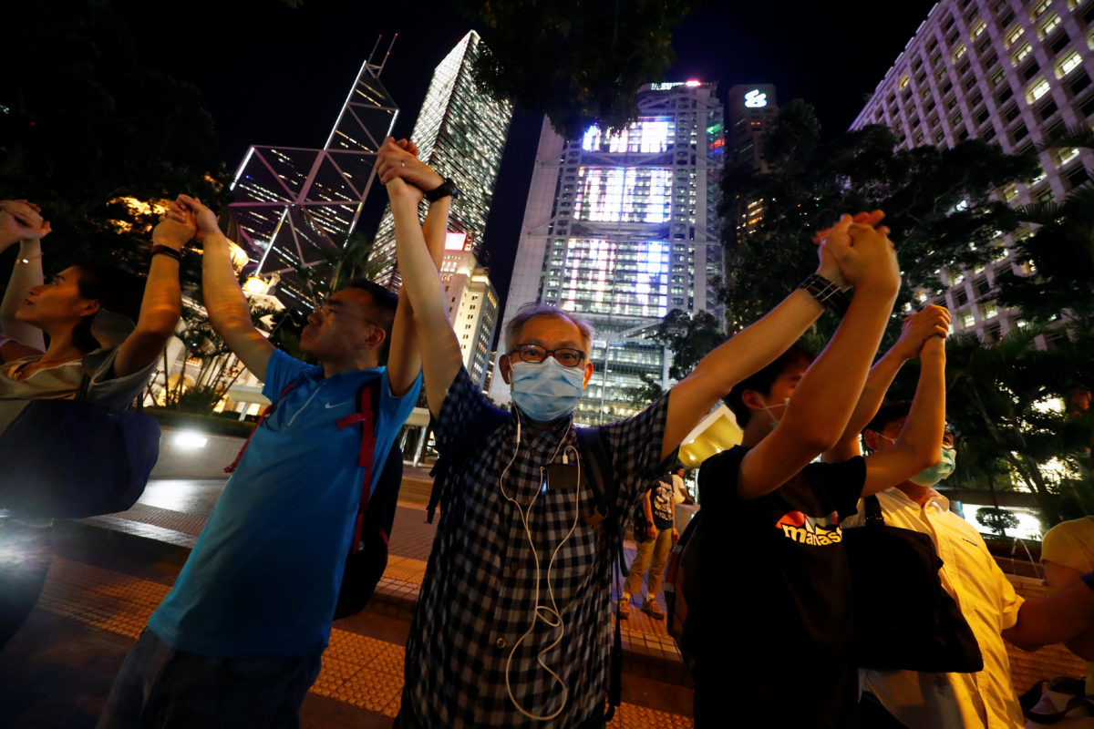 Hong Kong protesters form human chains to call for democracy | PBS News
