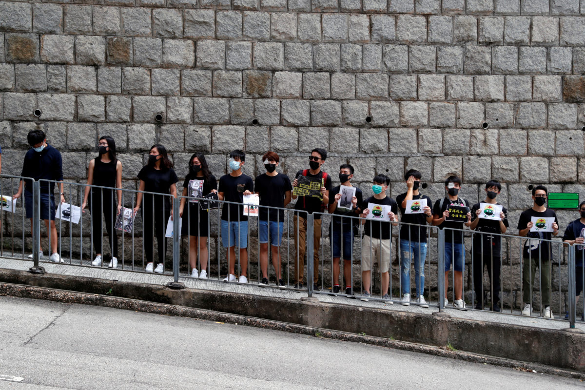 Hong Kong students form human chain, continuing protests | PBS News