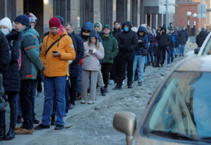 Russians line up at banks as currency plummets in face of sanctions ...