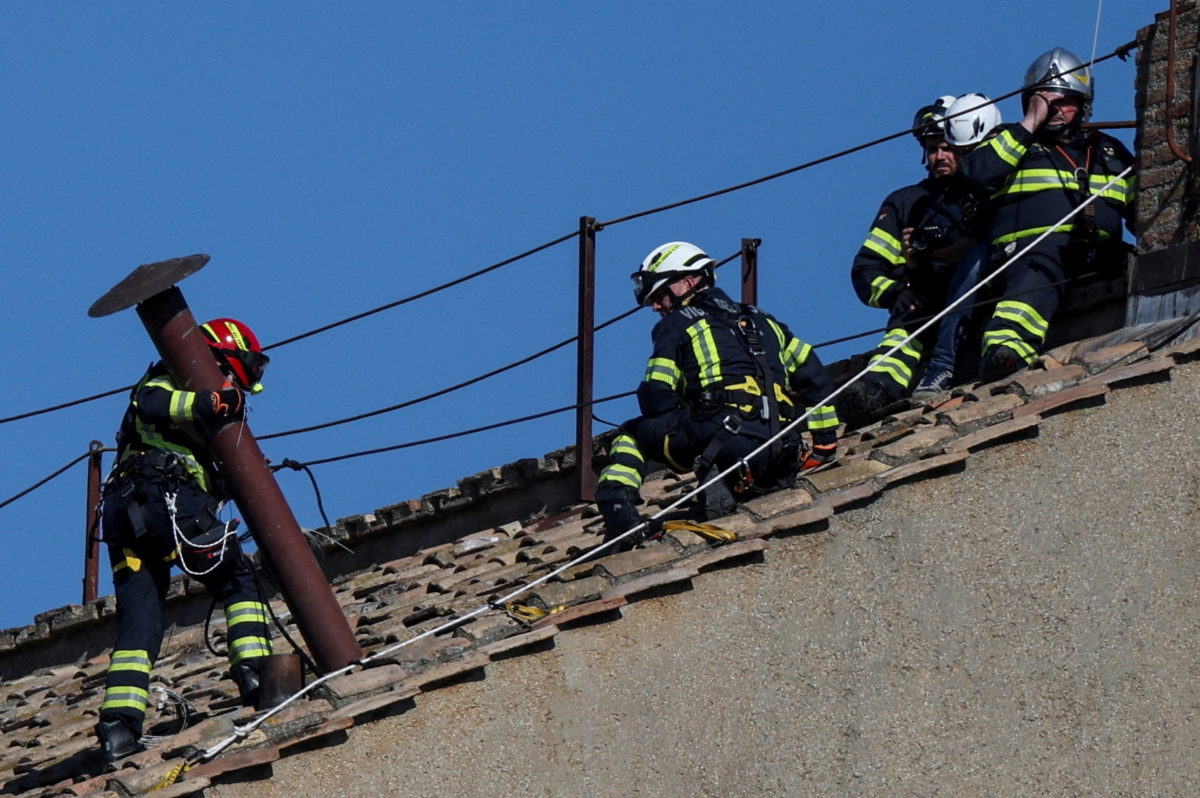 Vatican firefighters install chimney on Sistine Chapel roof for papal ...